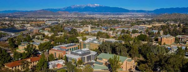 UC Riverside campus aerial view with snow capped mountains | School of Business